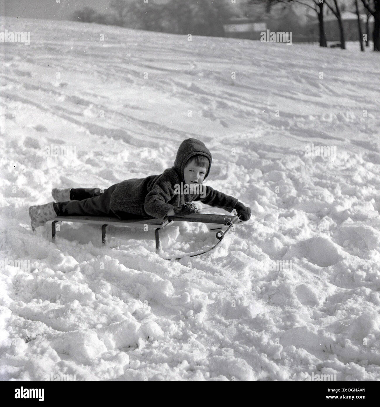 1960s, historical picture of a small child laying down on a wooden ...