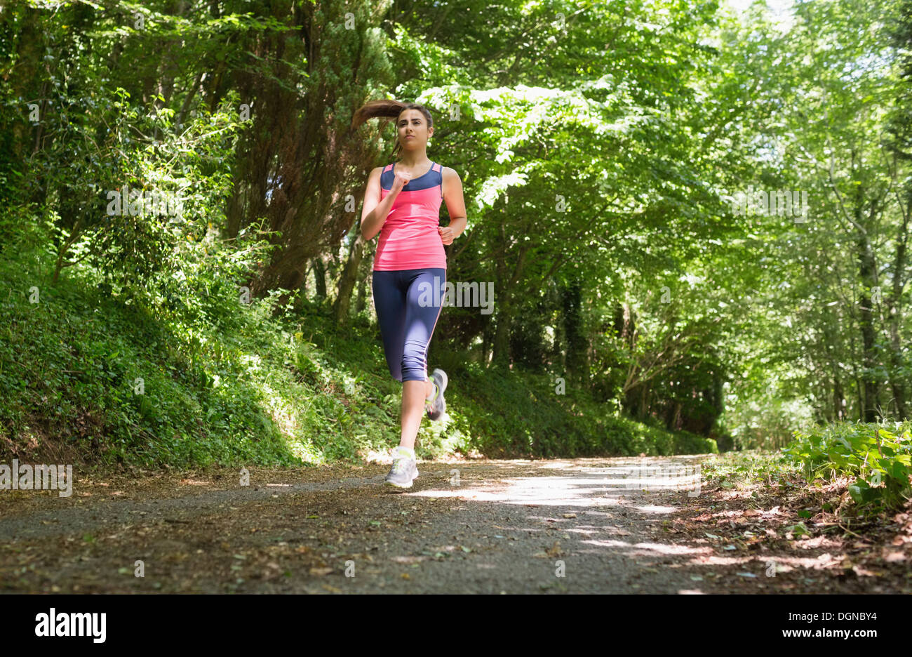Pretty young woman jogging Stock Photo - Alamy
