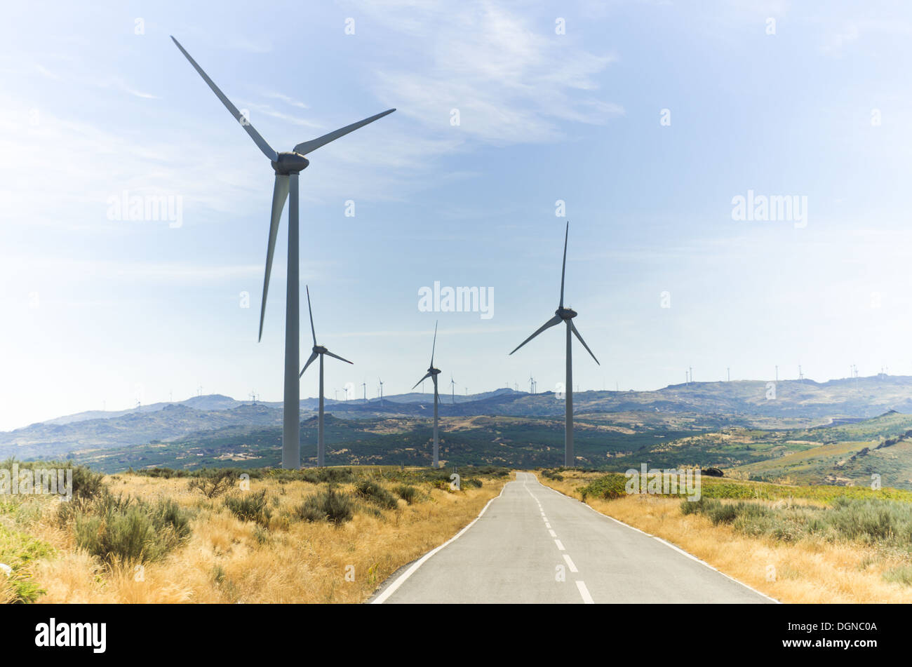 Asphalt road through a wind turbines mountain field Stock Photo - Alamy