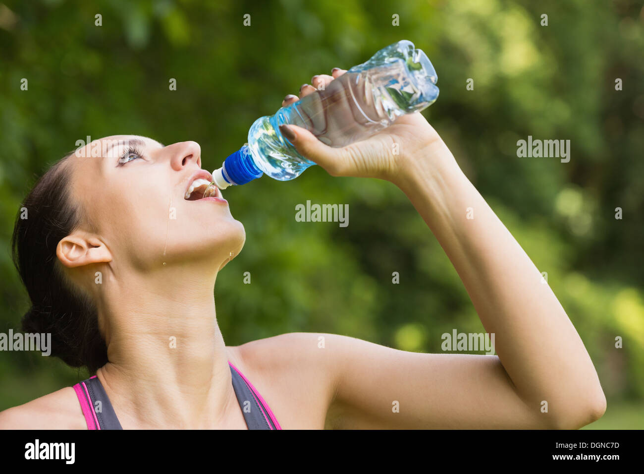 Fit woman drinking water from sports bottle Stock Photo - Alamy