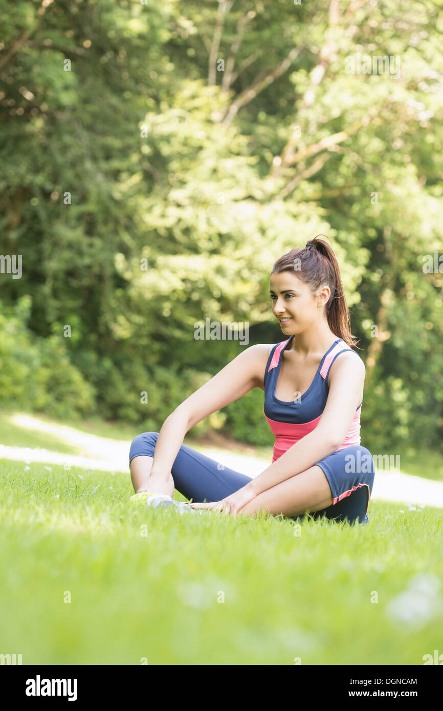 Beautiful fit woman sitting on the ground Stock Photo - Alamy
