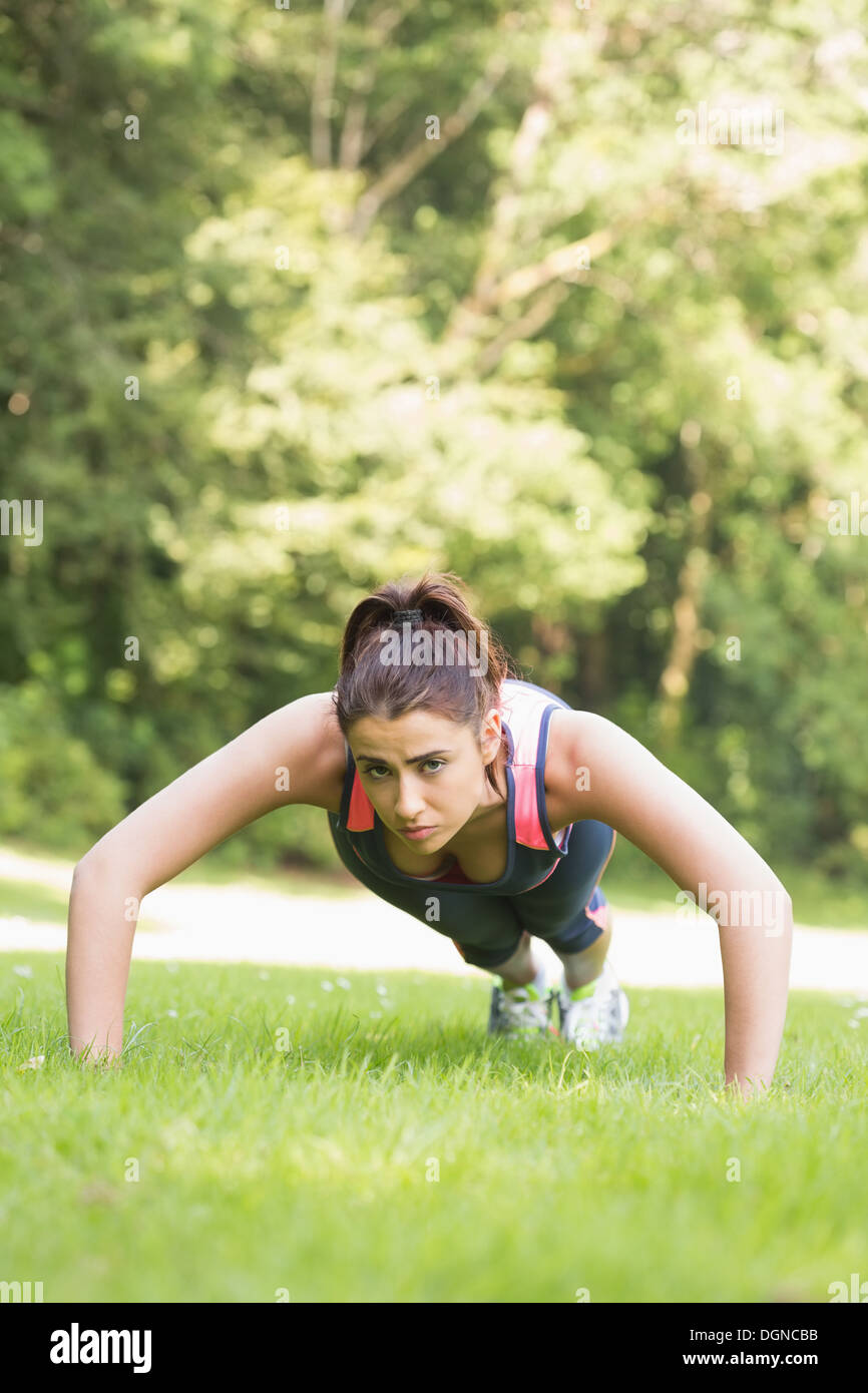 Focused fit woman doing plank position Stock Photo - Alamy