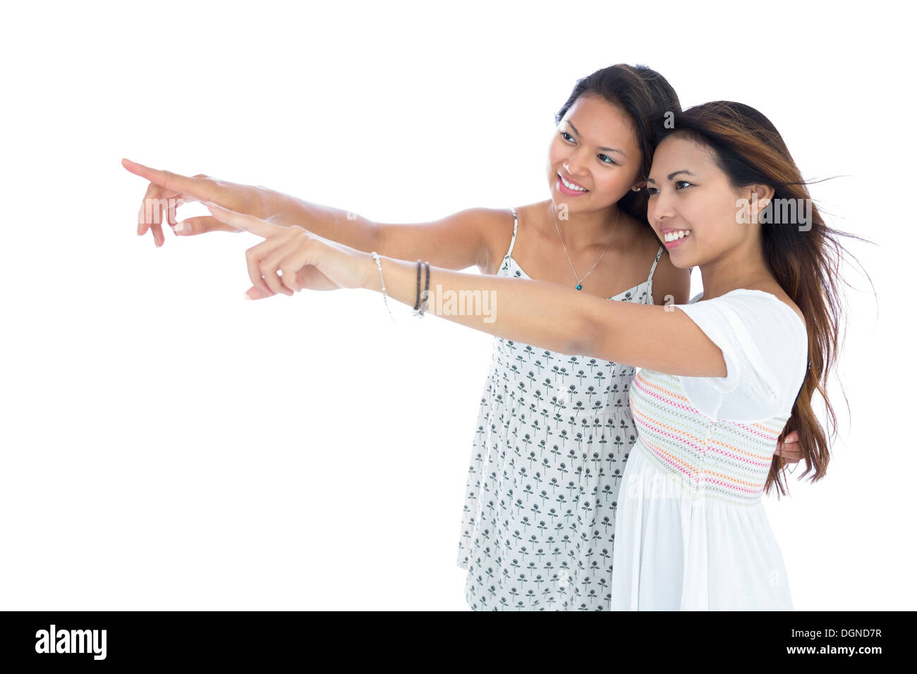 Two pretty young asian women pointing Stock Photo - Alamy