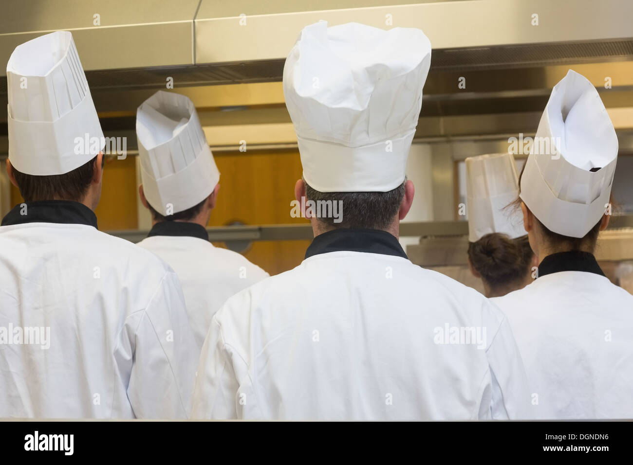 Five chefs standing in a kitchen Stock Photo - Alamy