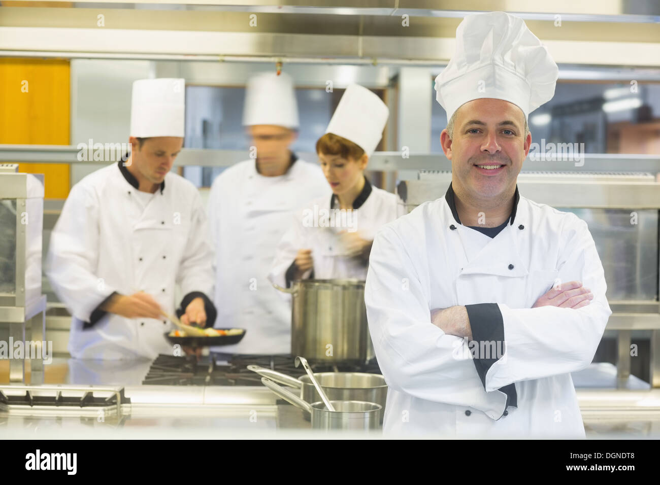 Mature male chef posing with crossed arms Stock Photo - Alamy