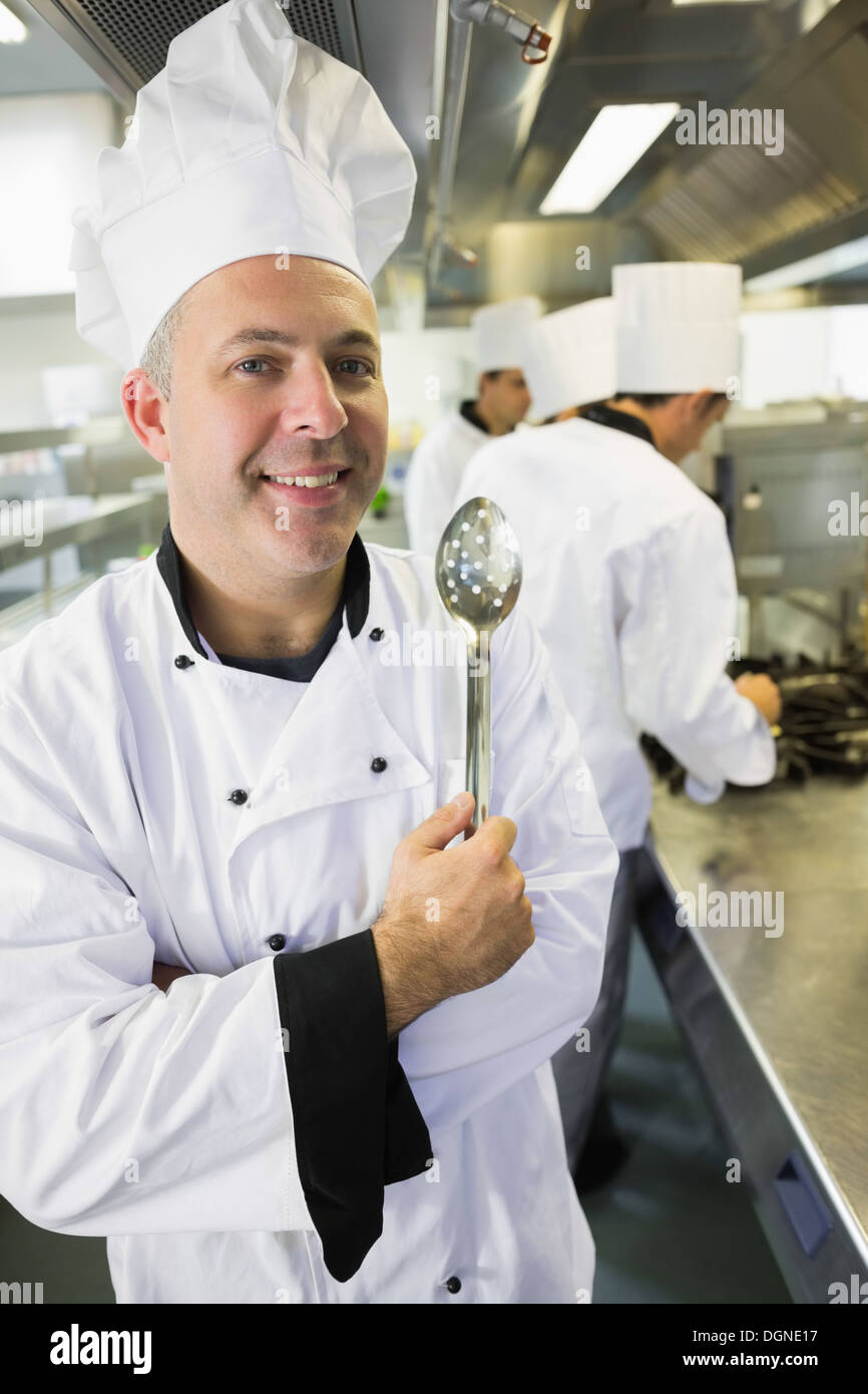 Senior chef posing proudly in a kitchen Stock Photo - Alamy