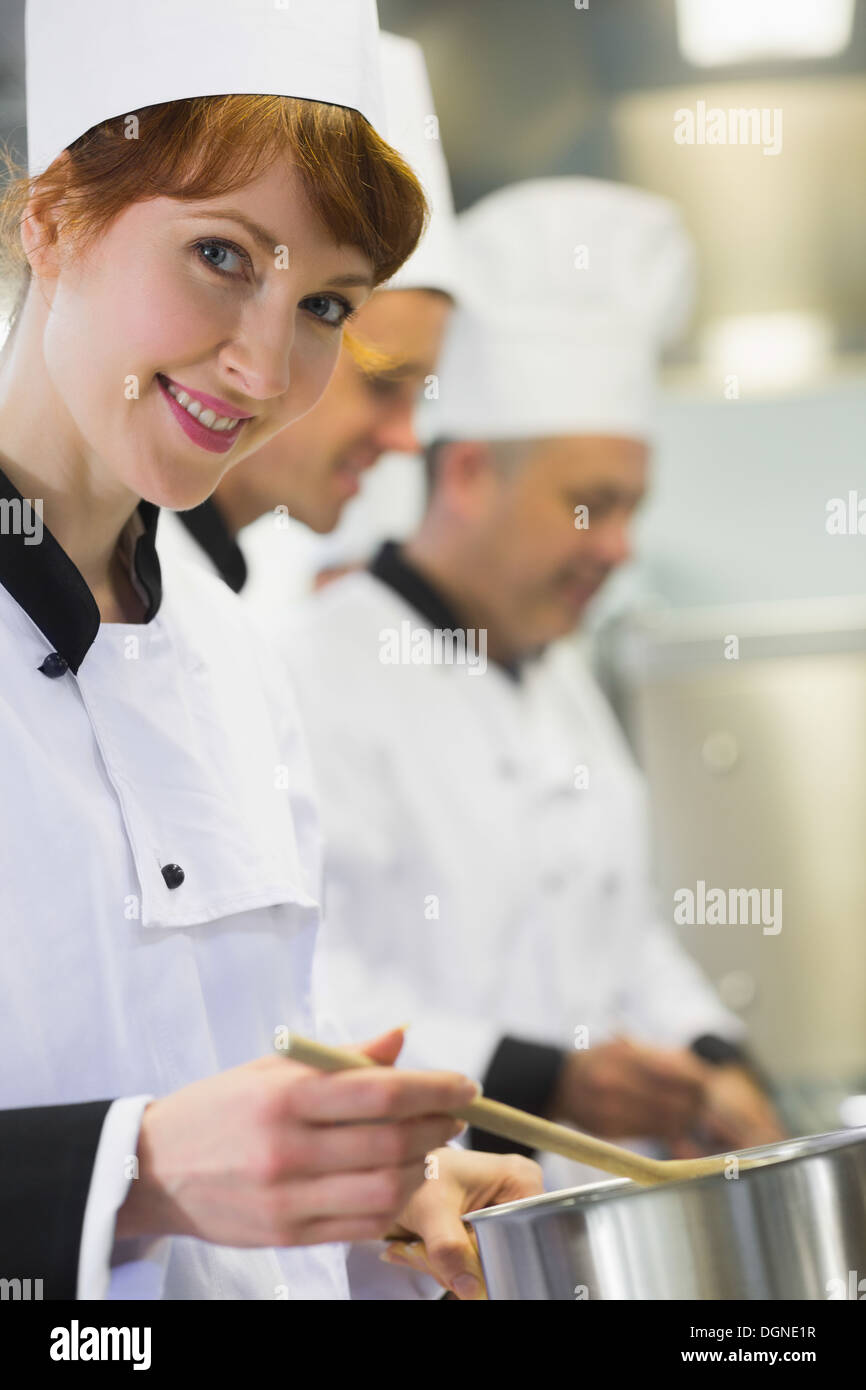Young female chef smiling at the camera Stock Photo - Alamy