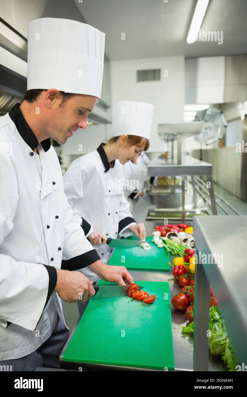 Two young chefs cutting vegetables Stock Photo - Alamy