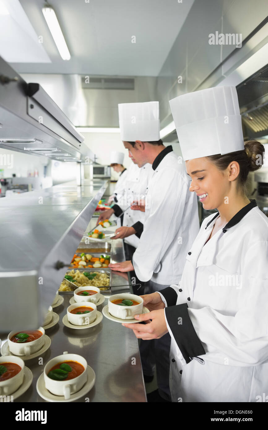 Four chefs working in a busy kitchen Stock Photo - Alamy