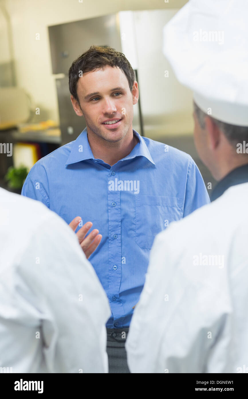 Young manager talking to the staff Stock Photo - Alamy