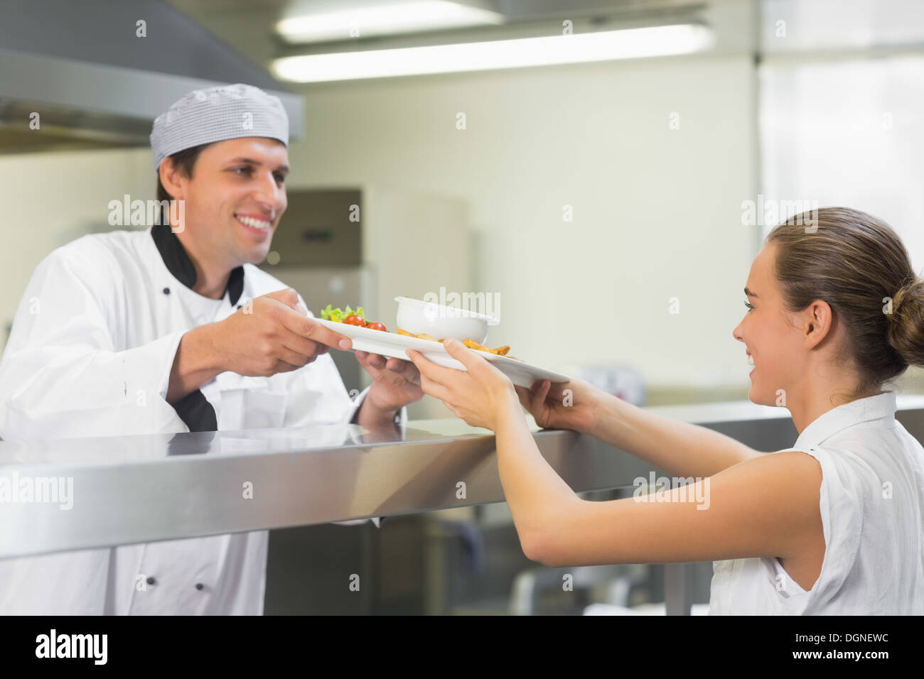 Chef handing food dish waitress hi-res stock photography and images - Alamy
