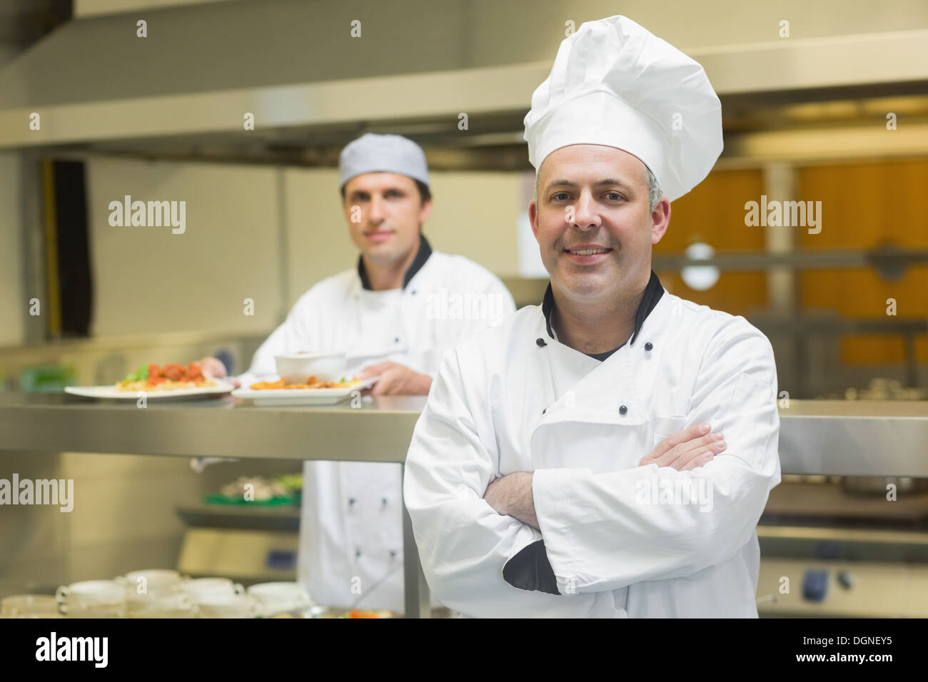 Mature chef posing proudly in a professional kitchen Stock Photo - Alamy