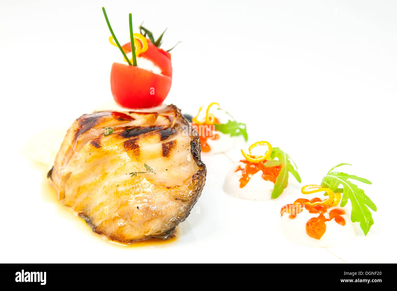 Roasted fillet of grilled fish in a white sauce Stock Photo - Alamy