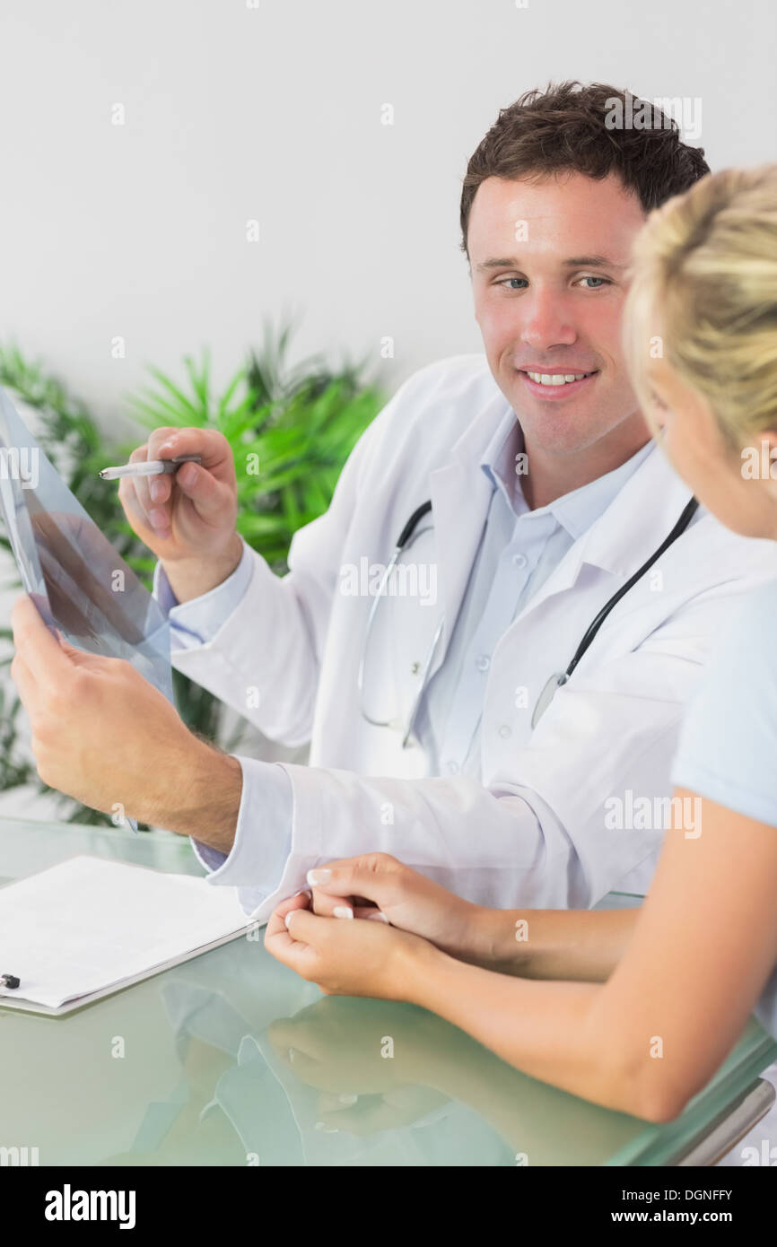 Smiling doctor showing a patient something on x-ray Stock Photo - Alamy