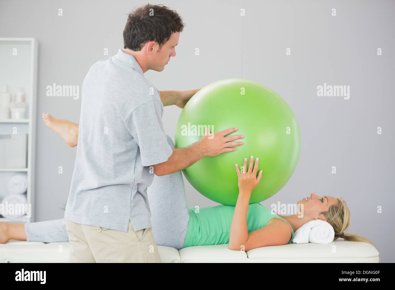 Patient training with exercise ball and physiotherapist Stock Photo - Alamy
