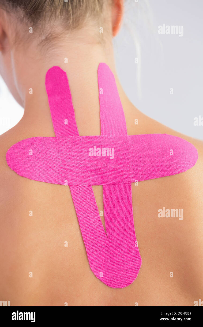 Female patients back with applied kinesio tape Stock Photo - Alamy
