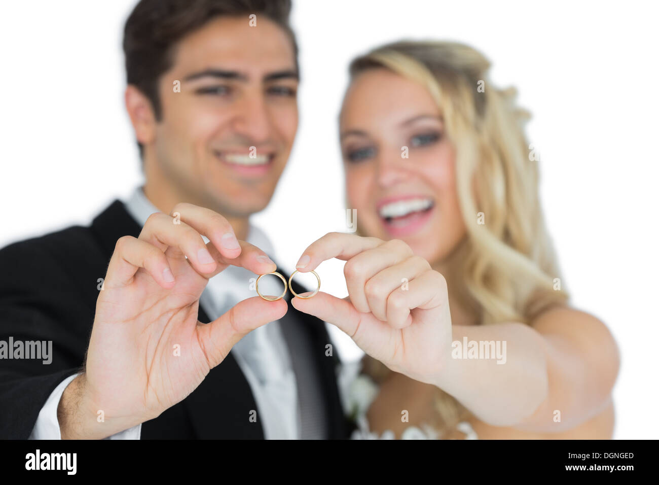 Cheerful married couple showing their wedding rings Stock Photo - Alamy