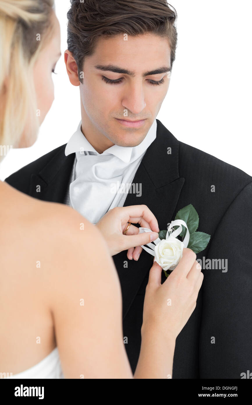 Young bride pinning a flower on her husbands suit Stock Photo - Alamy