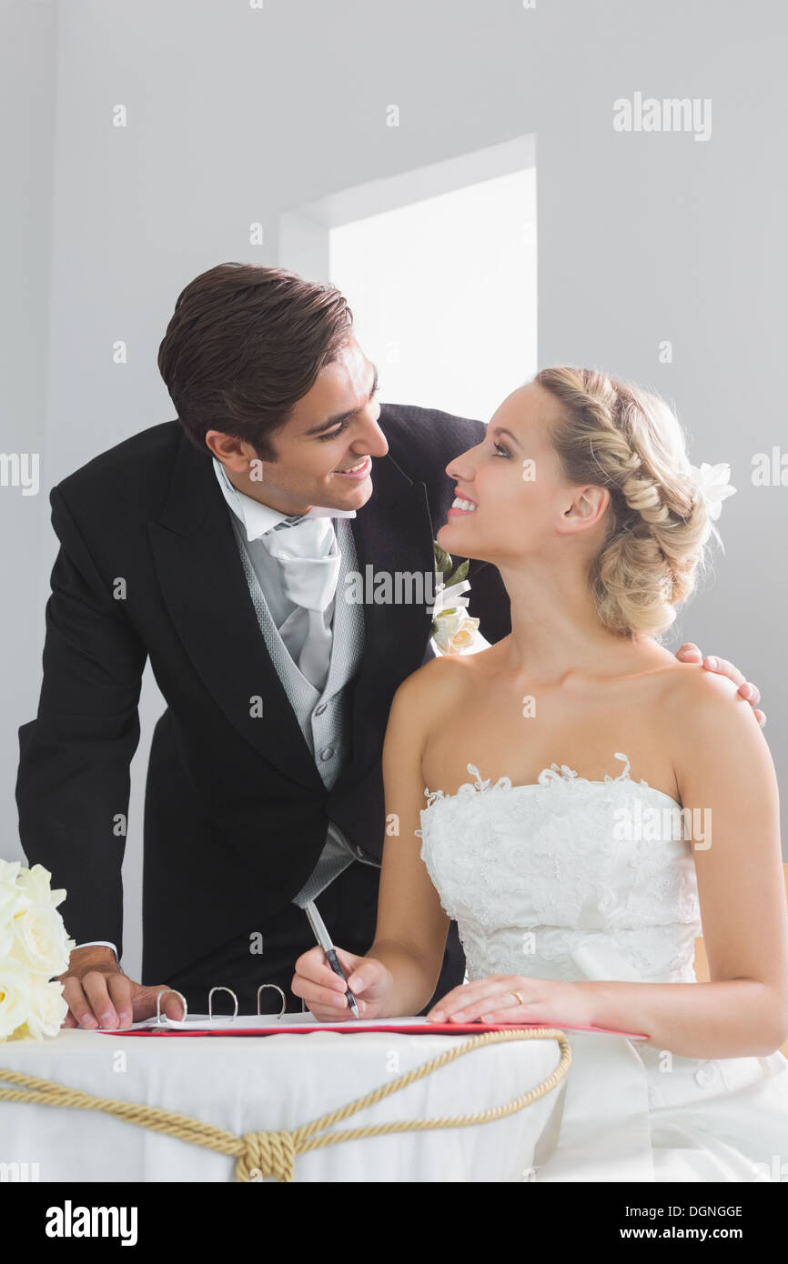 Beautiful blonde bride smiling at her husband Stock Photo - Alamy