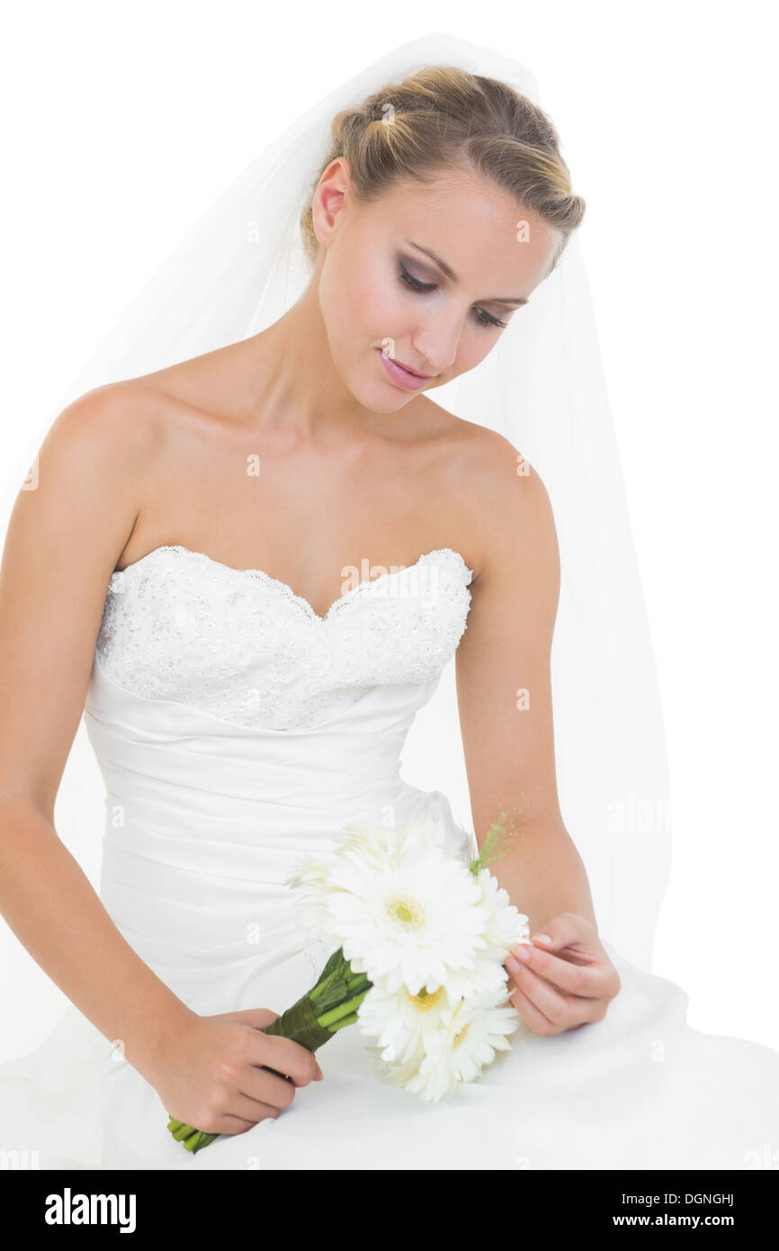 Lovely thoughtful bride sitting on ground Stock Photo - Alamy