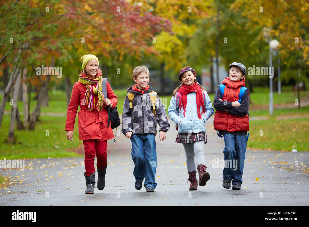 Portrait of happy schoolkids going to school Stock Photo - Alamy