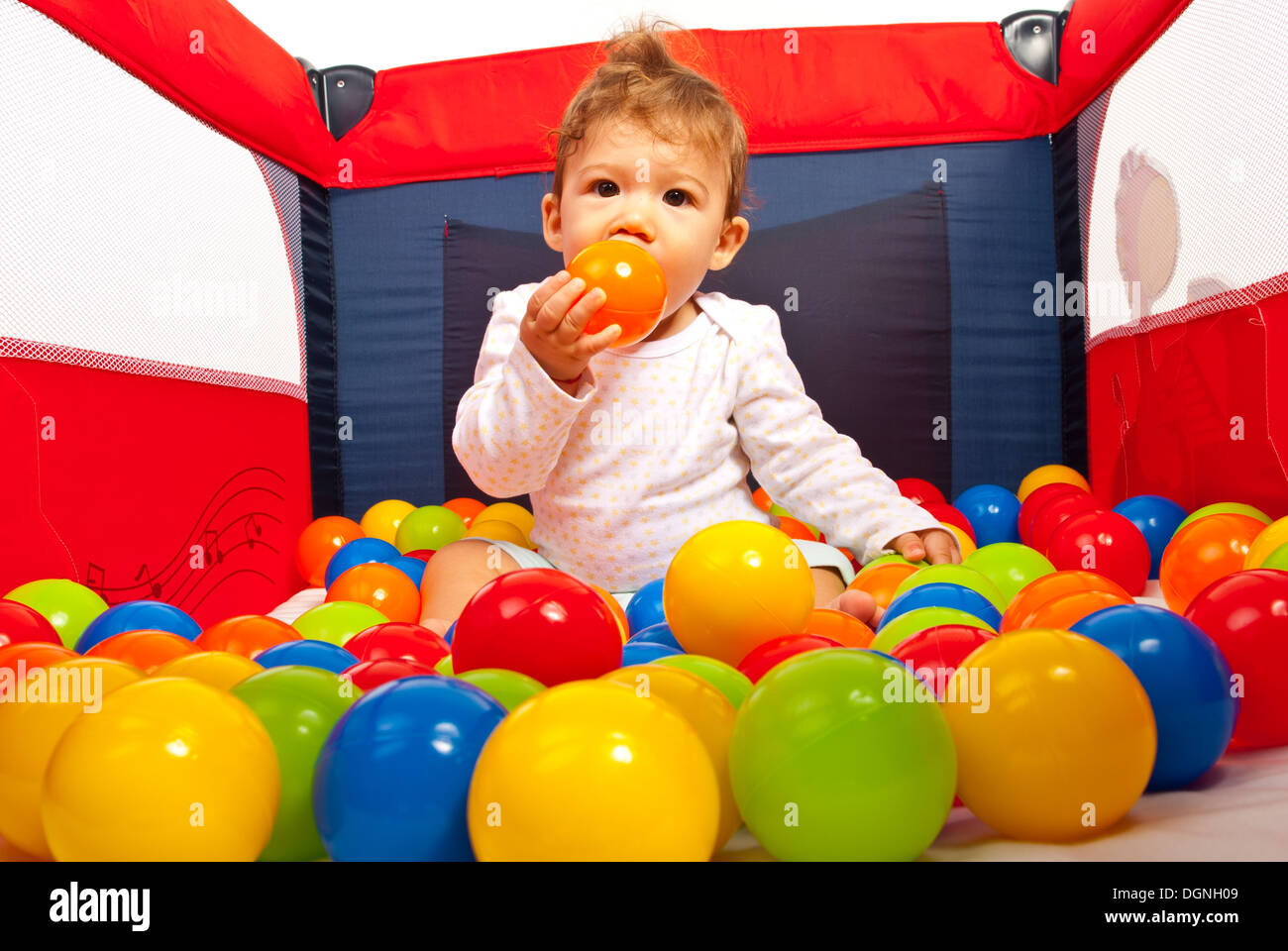 Baby boy inside playpen with colorful balls Stock Photo - Alamy