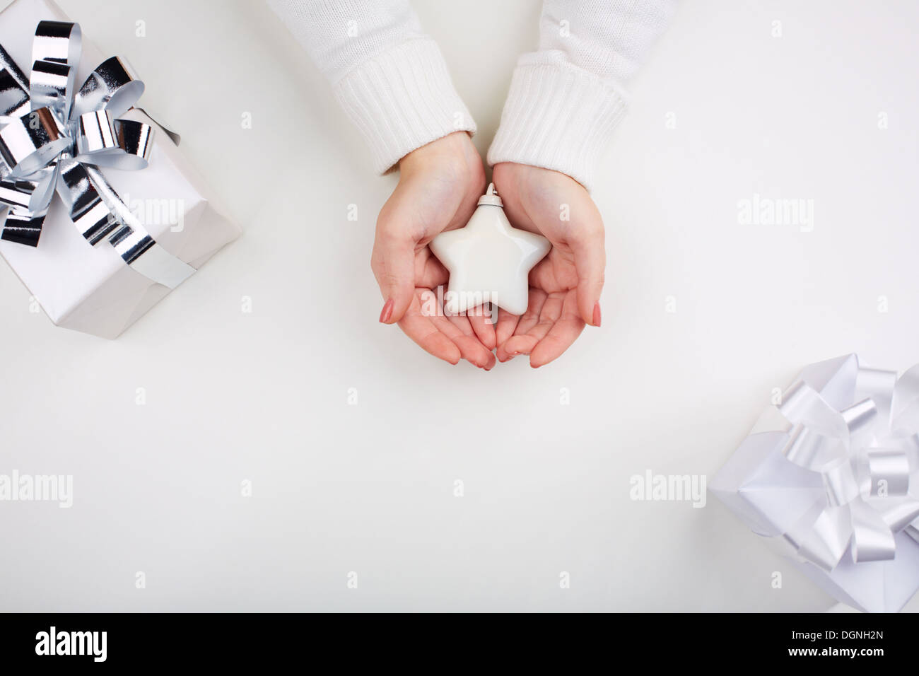 Image of decorative toy star on female hands surrounded by giftboxes ...