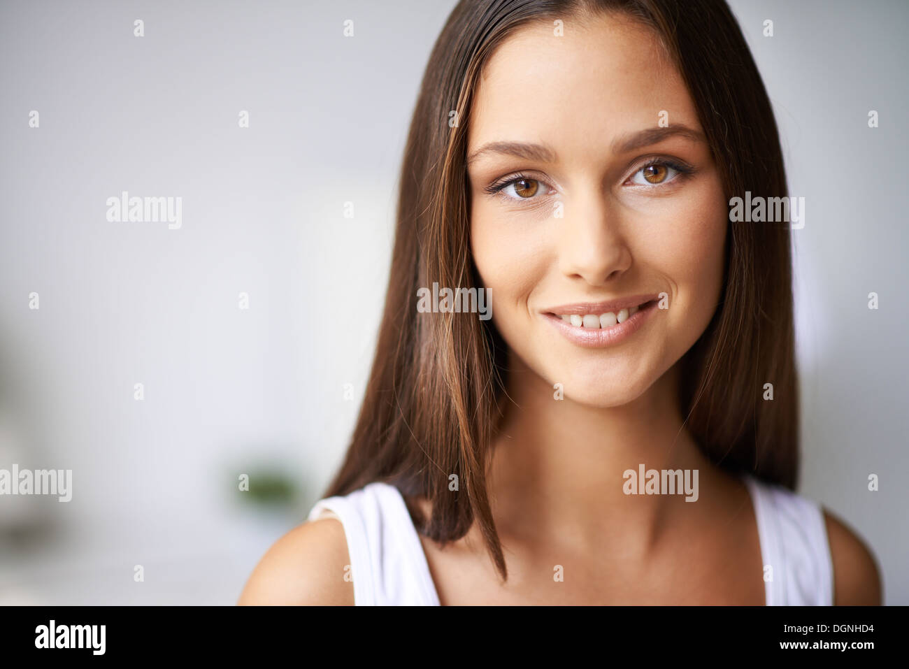 Calm female with dark hair looking at camera with smile Stock Photo - Alamy
