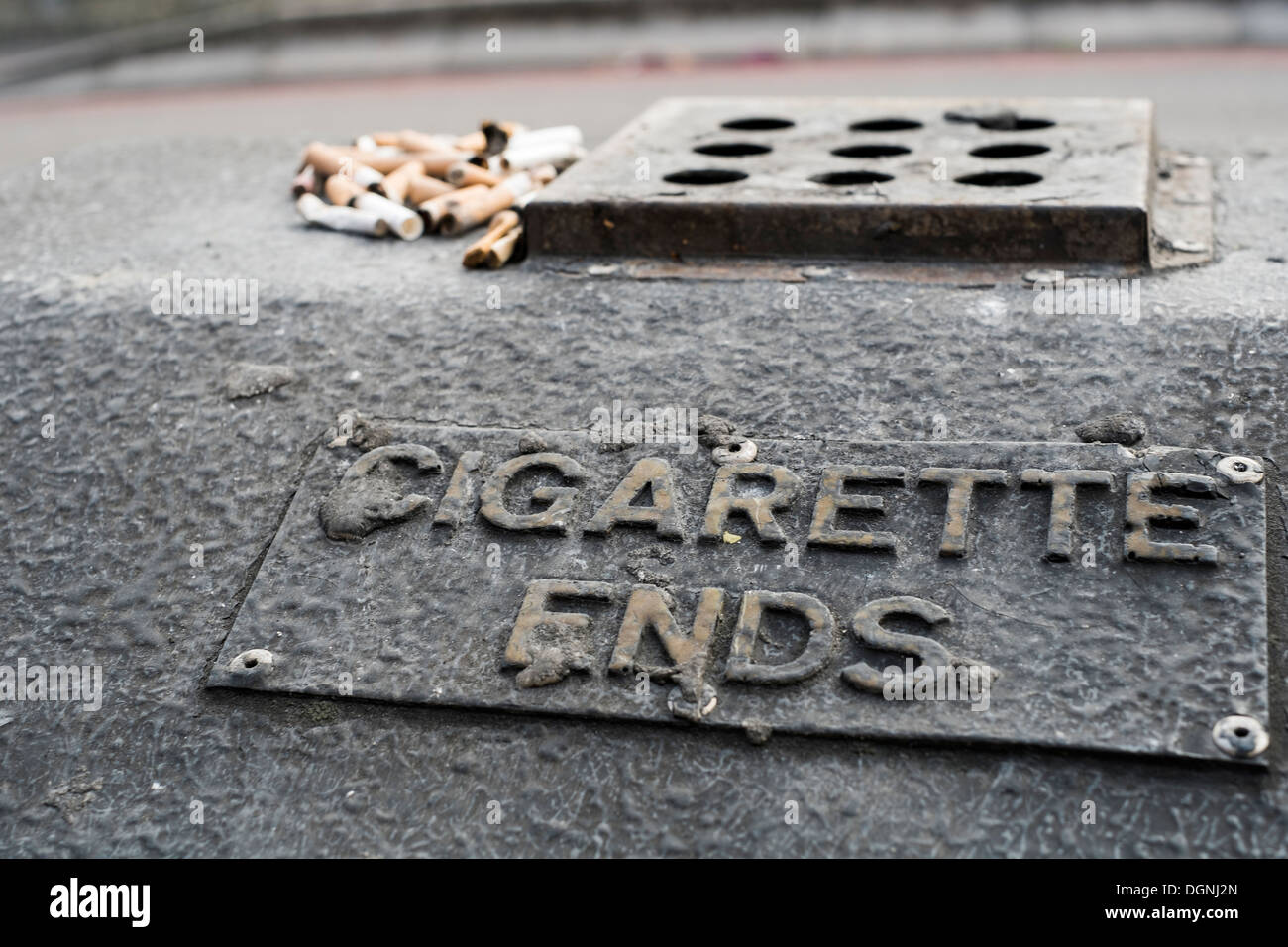Public ashtray with sign reading cigarette ends Stock Photo - Alamy