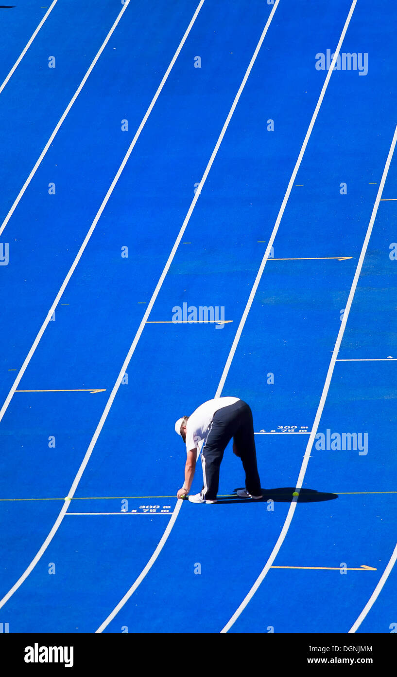 Blue running track inside a stadium Stock Photo - Alamy