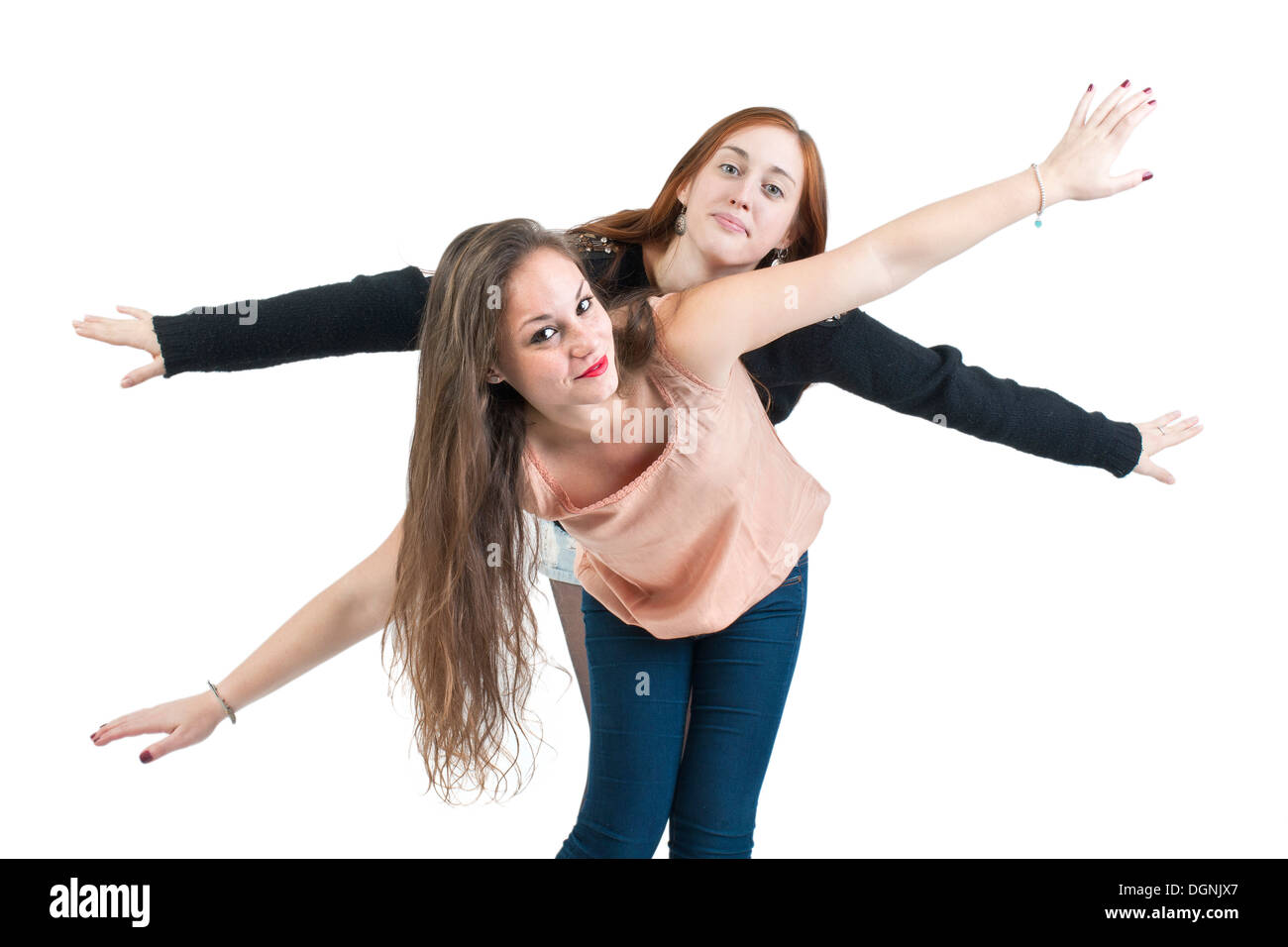 Two women with arms outstretched Stock Photo - Alamy