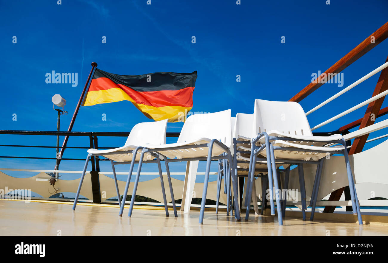 German flag flying behind empty rows of chairs on the rear of an ...