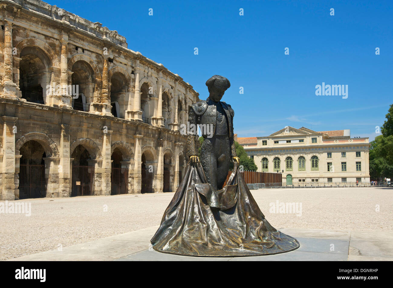 Statue of a bullfighter in front of the Roman amphitheatre, Nîmes ...