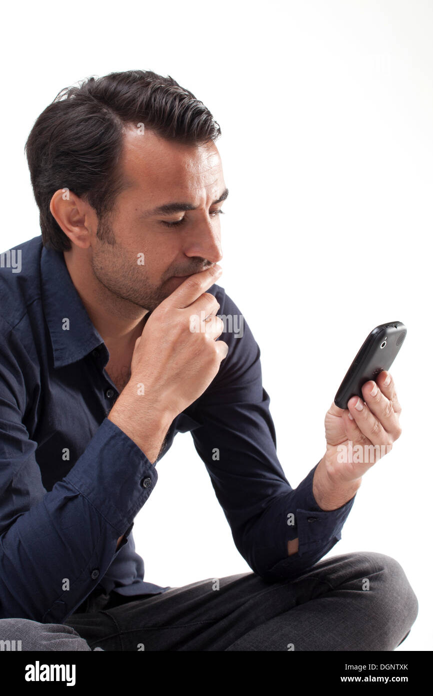 Man looking at a mobile phone Stock Photo - Alamy