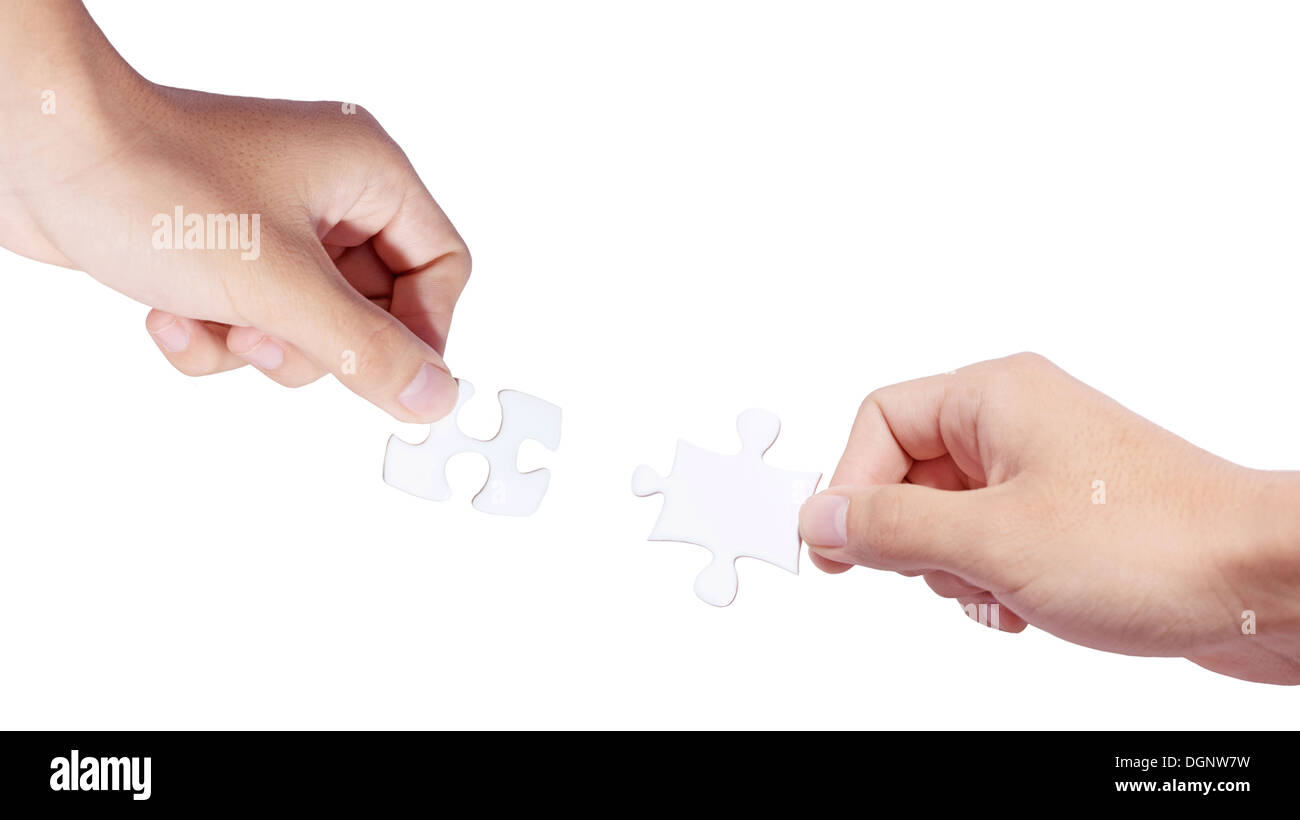 Two hands holding puzzle pieces and connecting them Stock Photo - Alamy