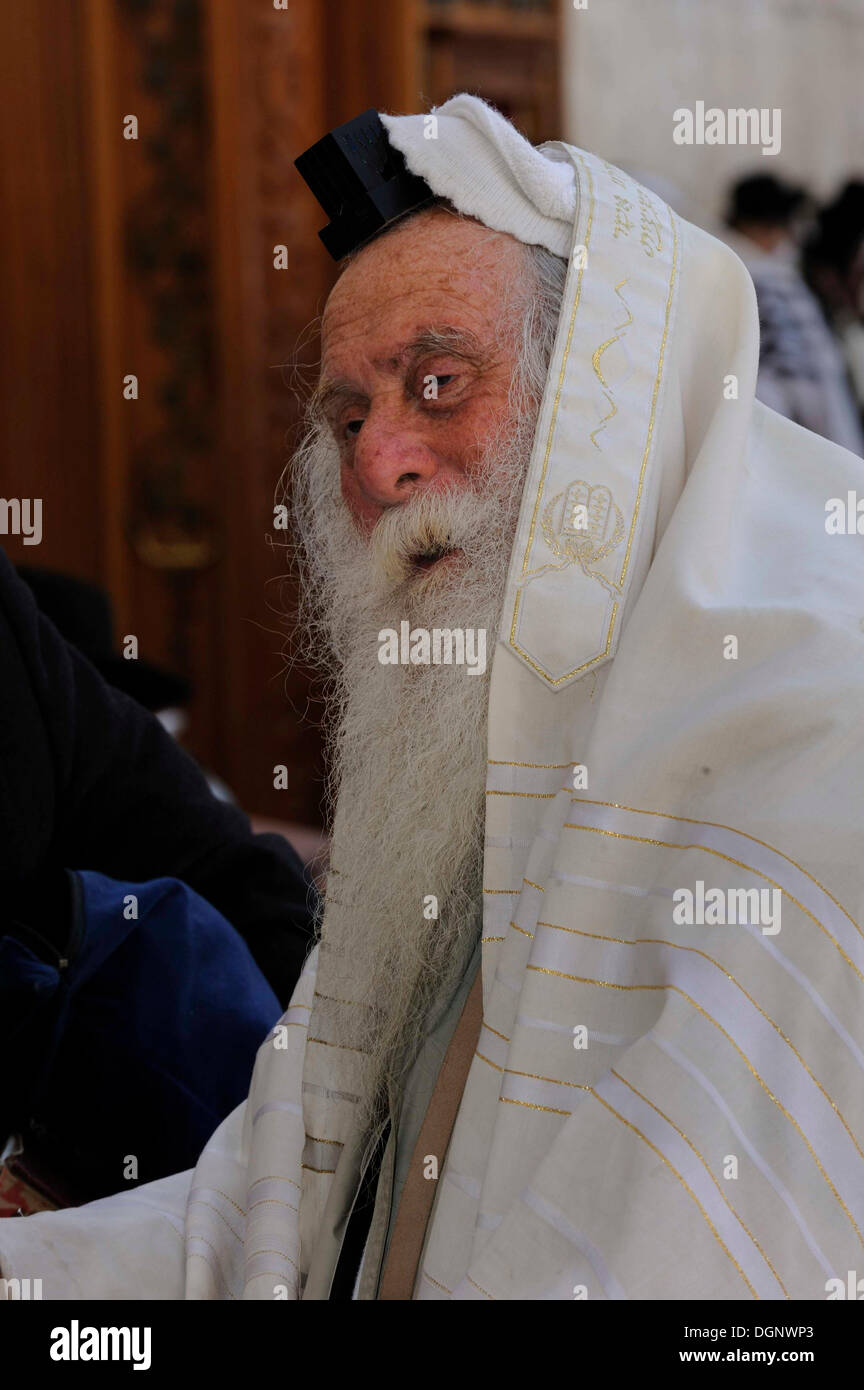 Jew in front of the Torah cabinet with a tefillin on his head and a ...