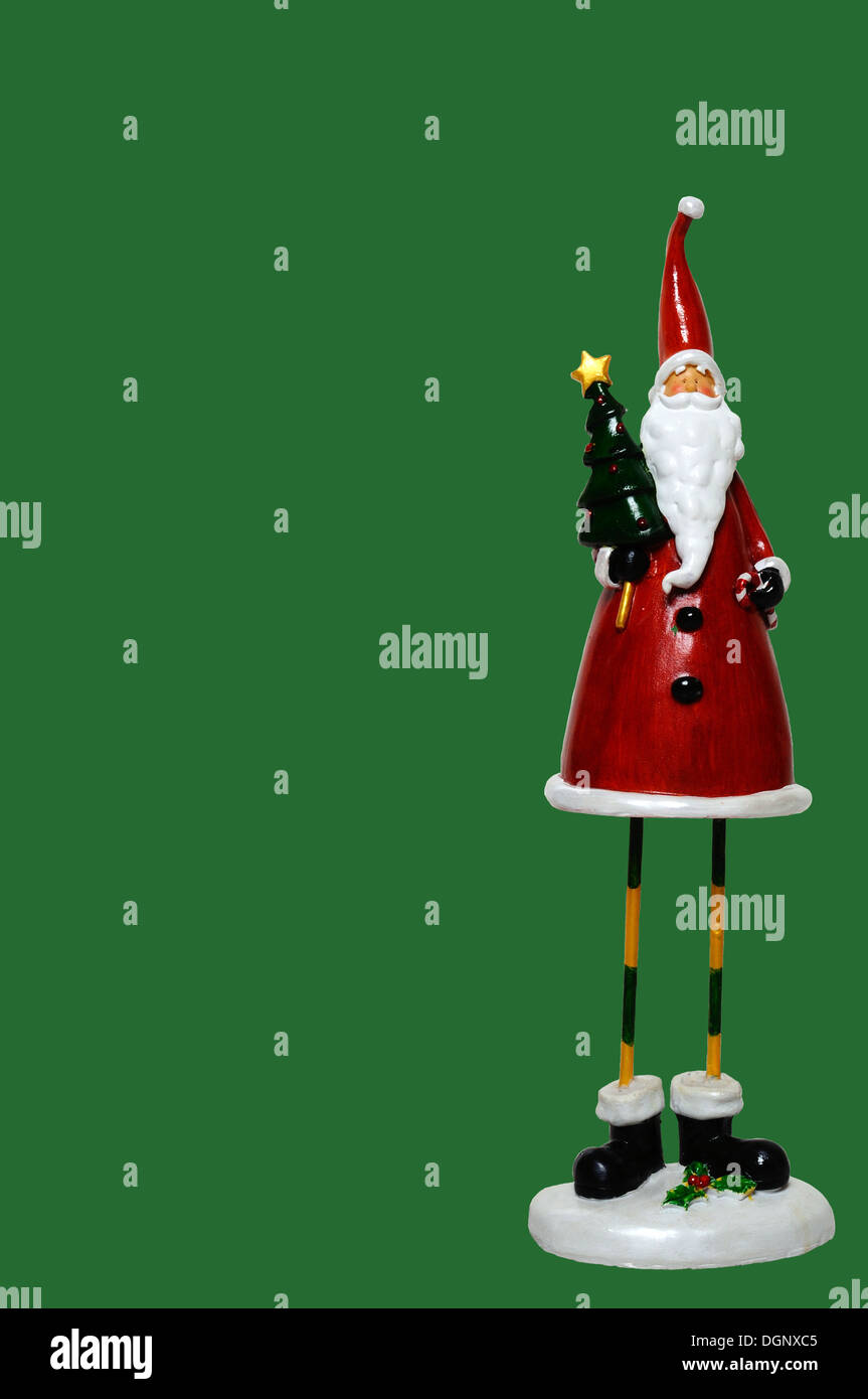 Father Christmas statue against a green background Stock Photo - Alamy