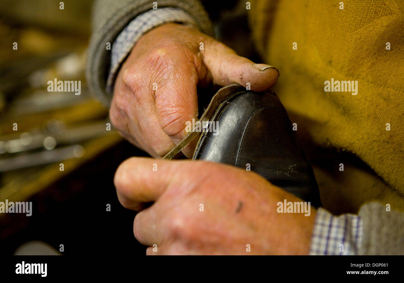 Shoemaker cuts sole shoe hi-res stock photography and images - Alamy