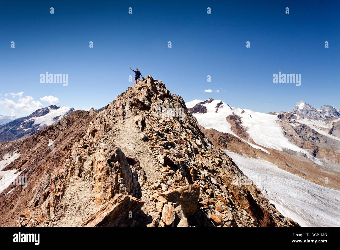 Mountaineer standing on a ridge, crossing Cima Venezia mountain ...