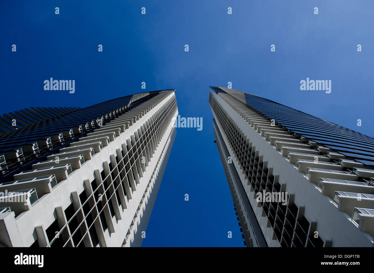 Two skyscrapers from below with blue sky in the background Stock Photo ...