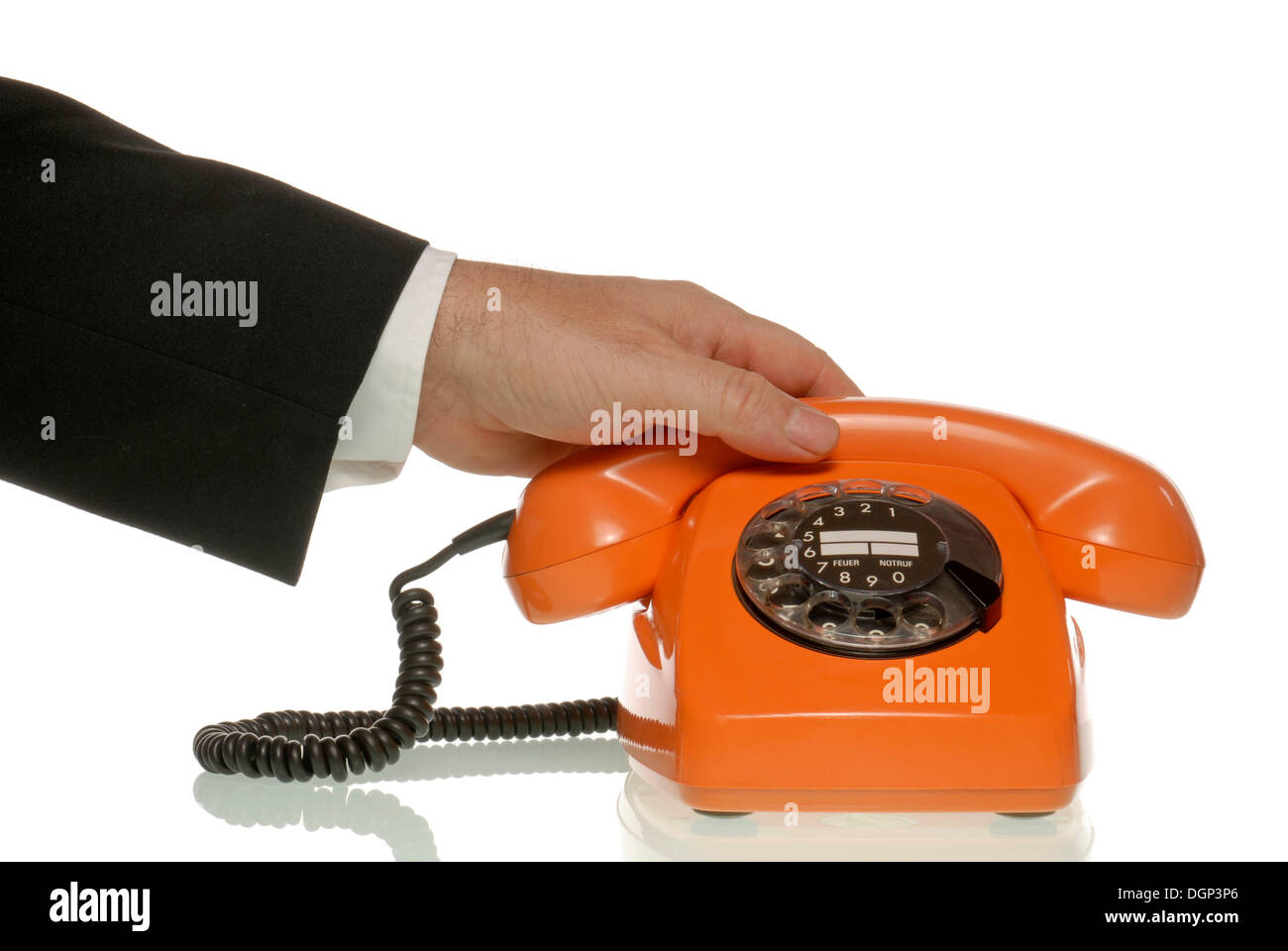 Business man reaching for an orange telephone Stock Photo - Alamy