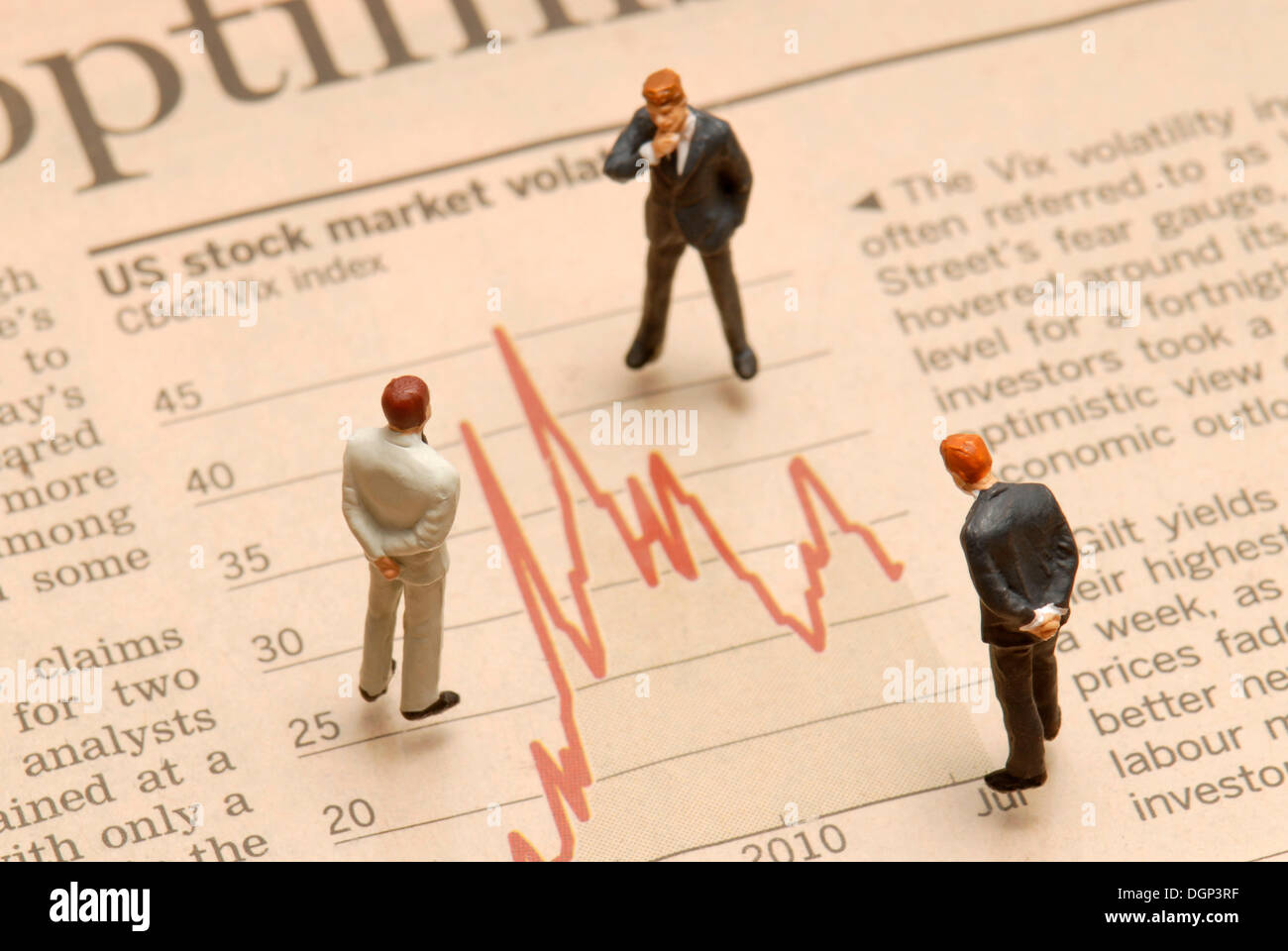 Miniature businessmen figures standing on a stock market chart Stock ...
