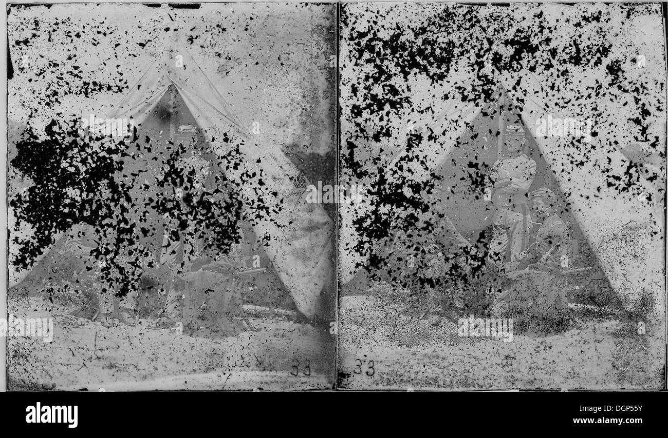 Soldiers gathered around a tent, possibly in a military or wartime ...