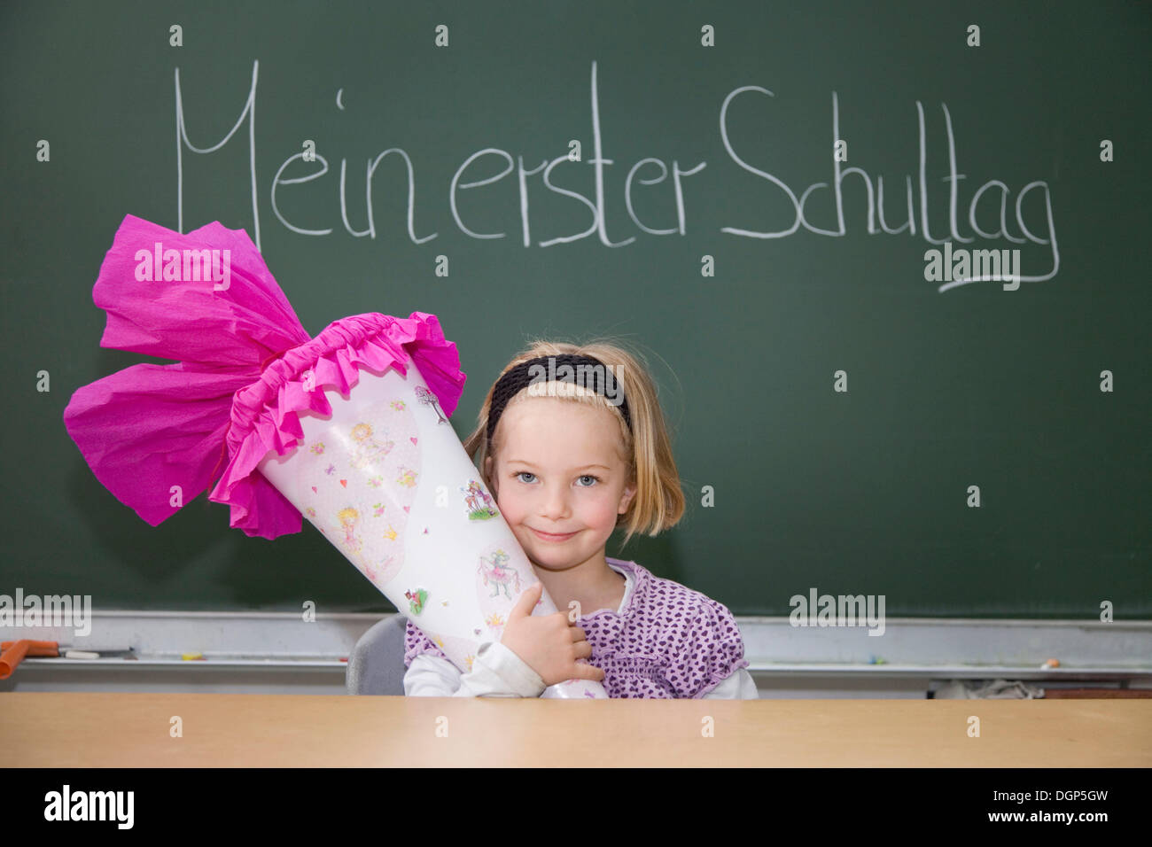 Girl with a cone of sweets on her first day of school Stock Photo - Alamy
