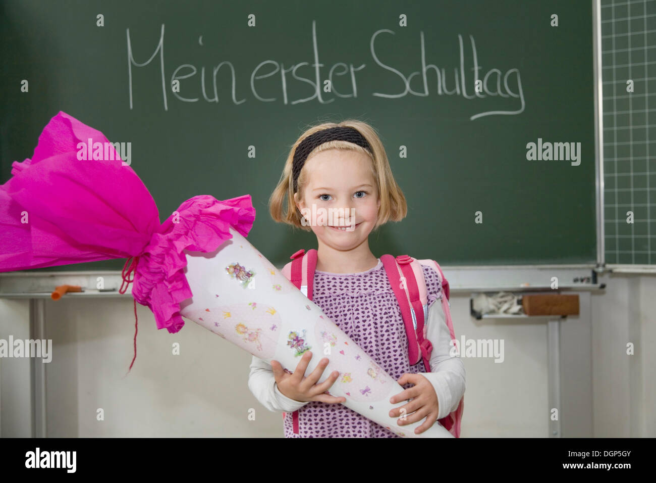 Girl with a cone of sweets on her first day of school Stock Photo - Alamy