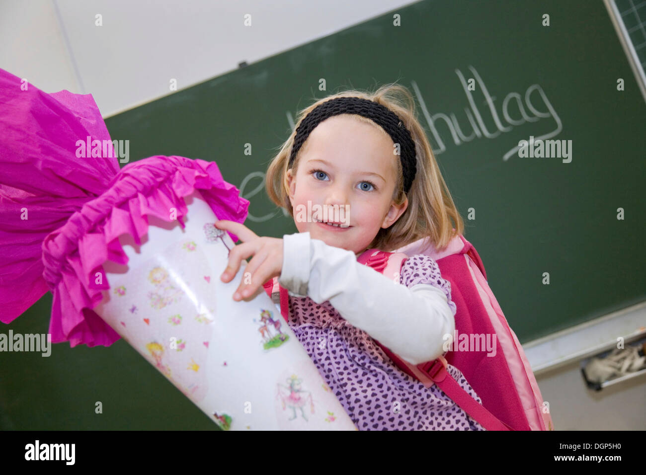 Girl with a cone of sweets on her first day of school Stock Photo - Alamy
