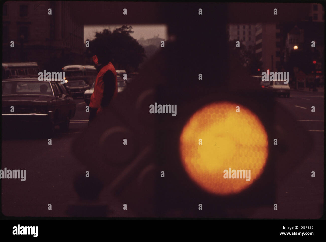 A traffic officer manages traffic at a busy intersection, ensuring the ...