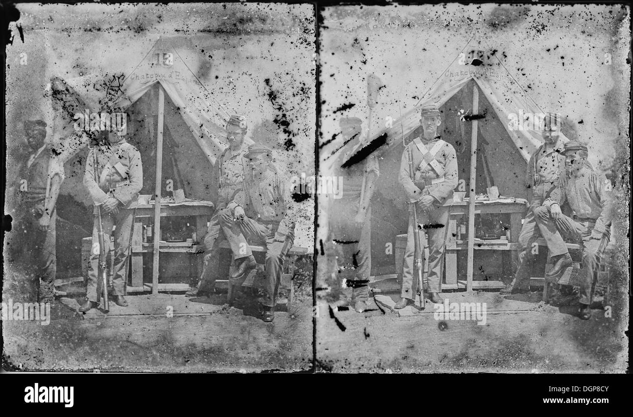 Soldiers are seen at a tent in a military setting, likely during a ...