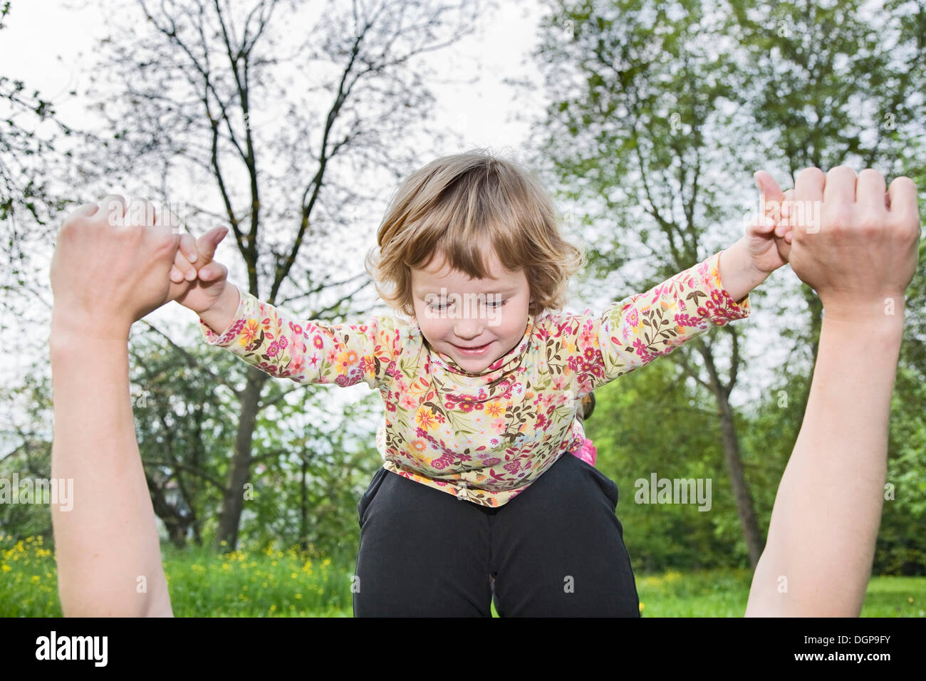Girl playing with her mother, "One, two, three, whee! Stock Photo - Alamy