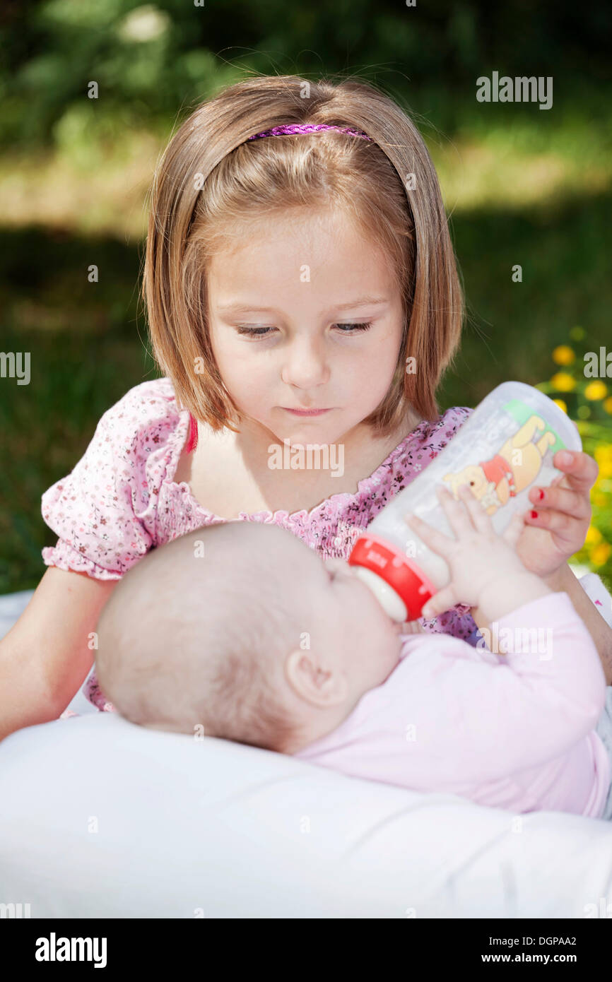 Feeding Baby Bottle Sister Stock Photos & Feeding Baby Bottle Sister ...